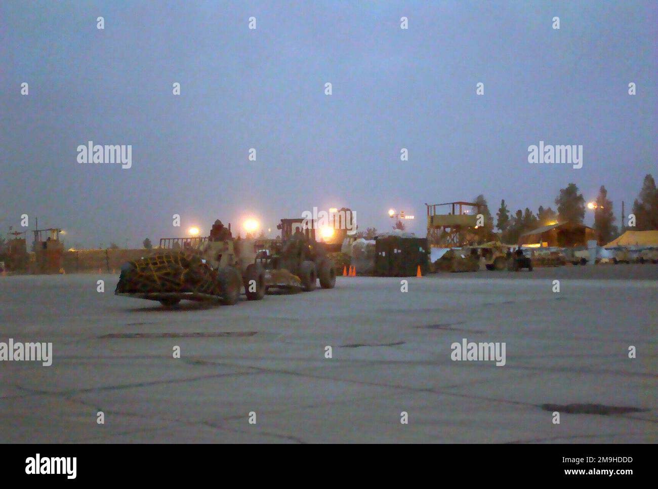 As darkness fall, Air Force 10K-AT forklifts, with their loads, make ...