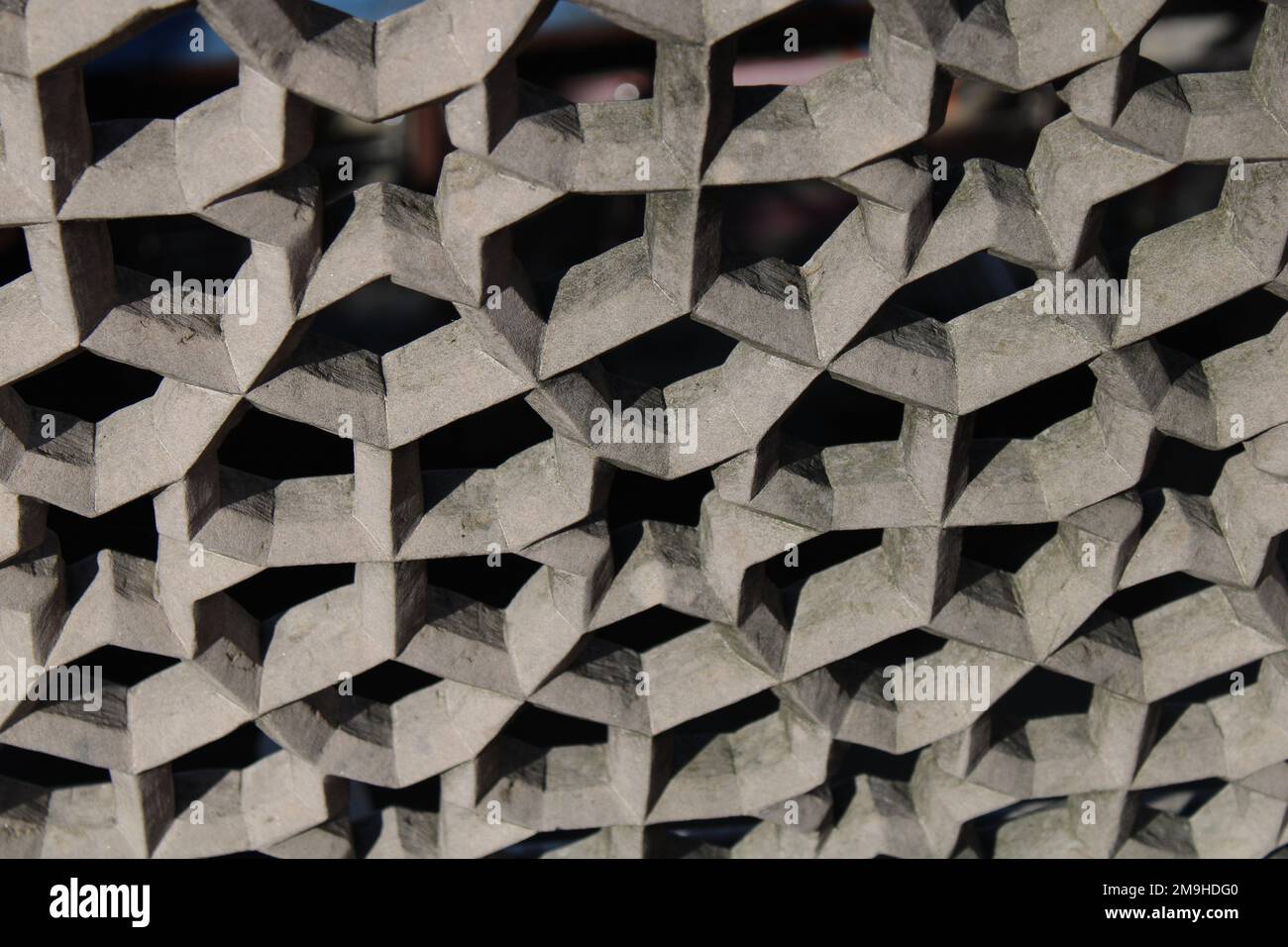 An old stone wall with patterns covered in green moss on a bright ...