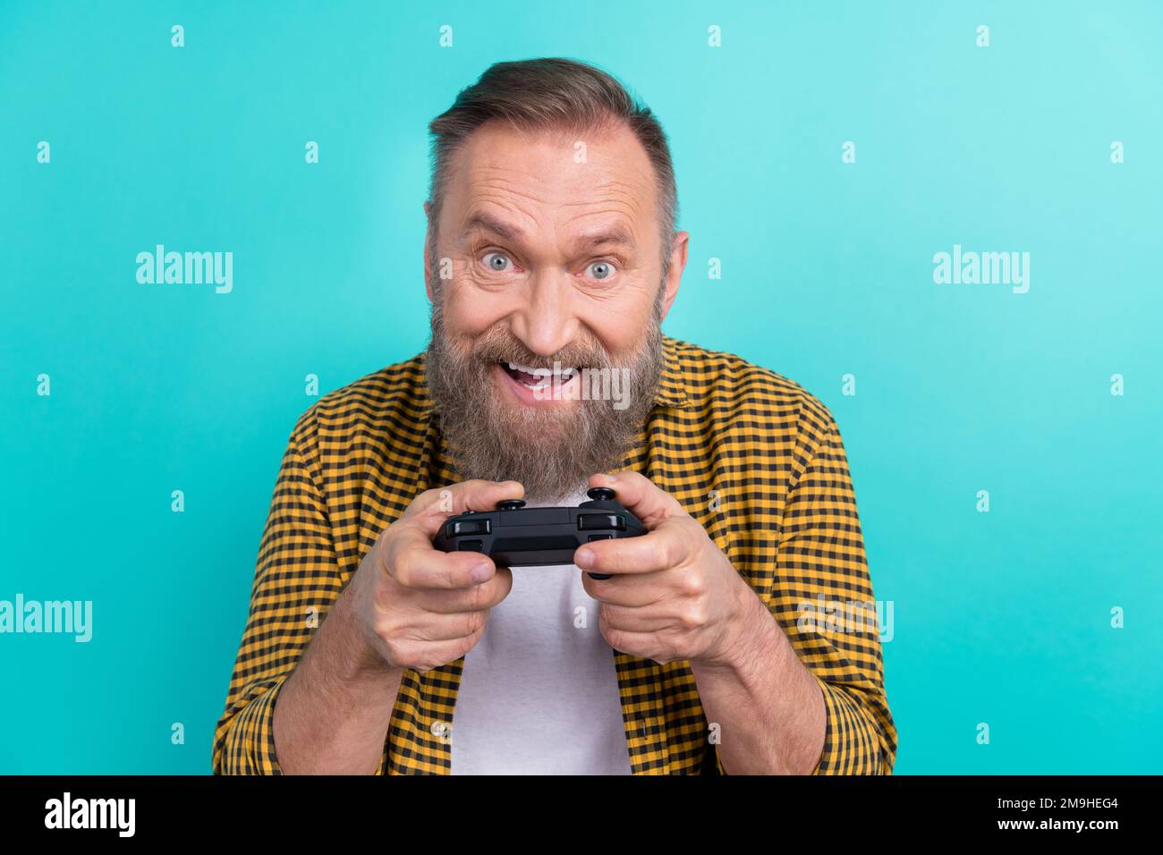 Closeup photo of mature age guy wear trendy yellow shirt playing video ...
