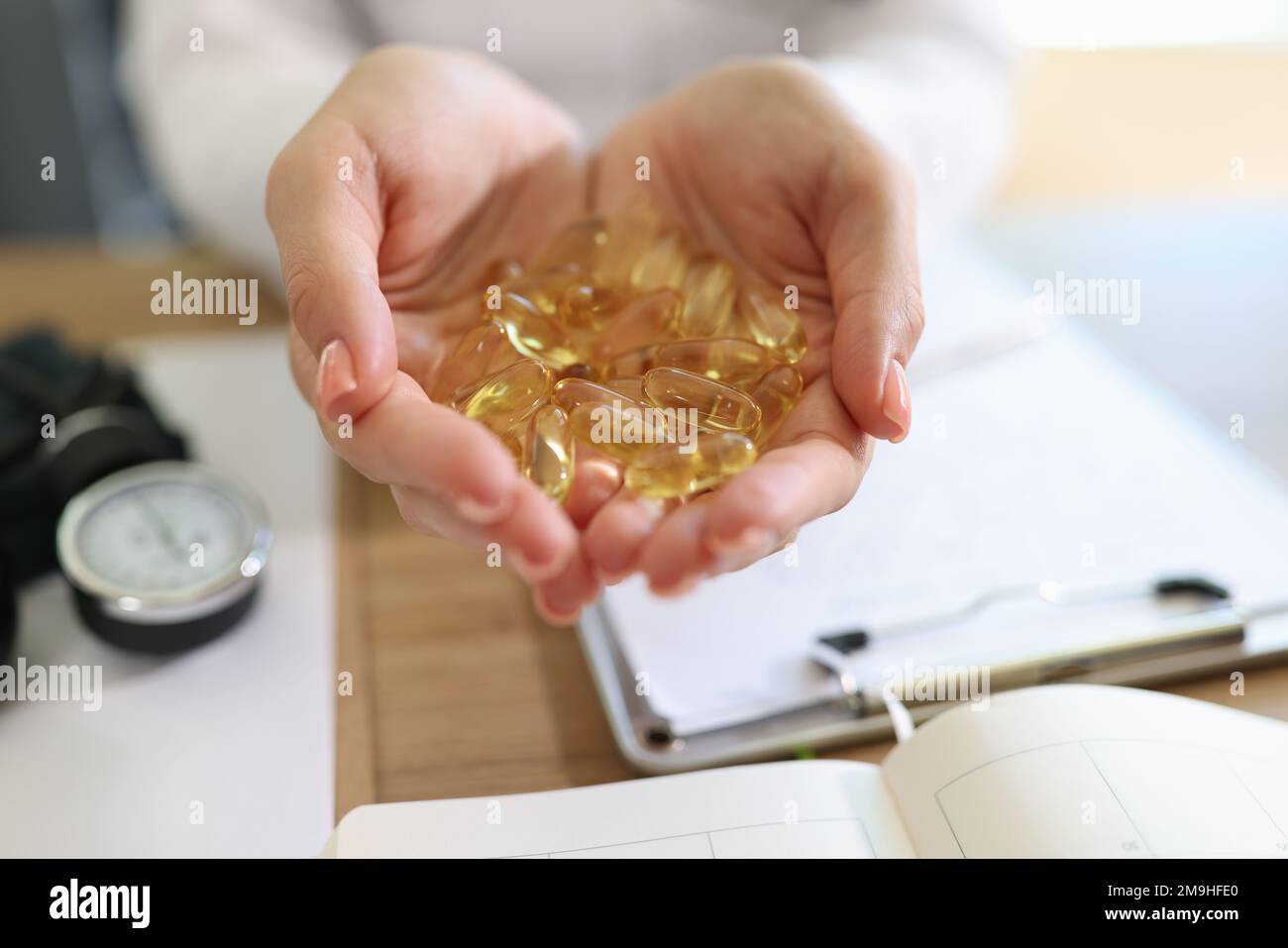 Doctor holding many omega capsules hi-res stock photography and images ...