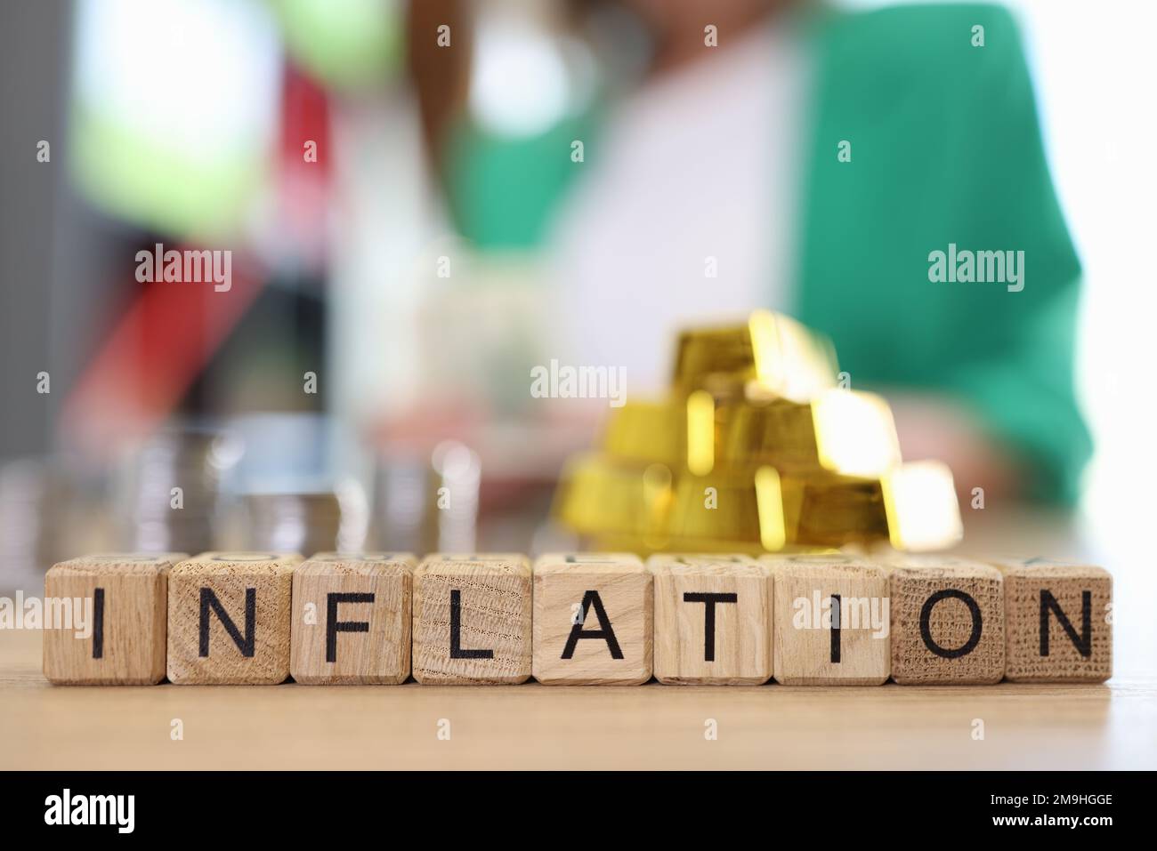 Word inflation collected from wooden cubes with gold bars and stacks of ...
