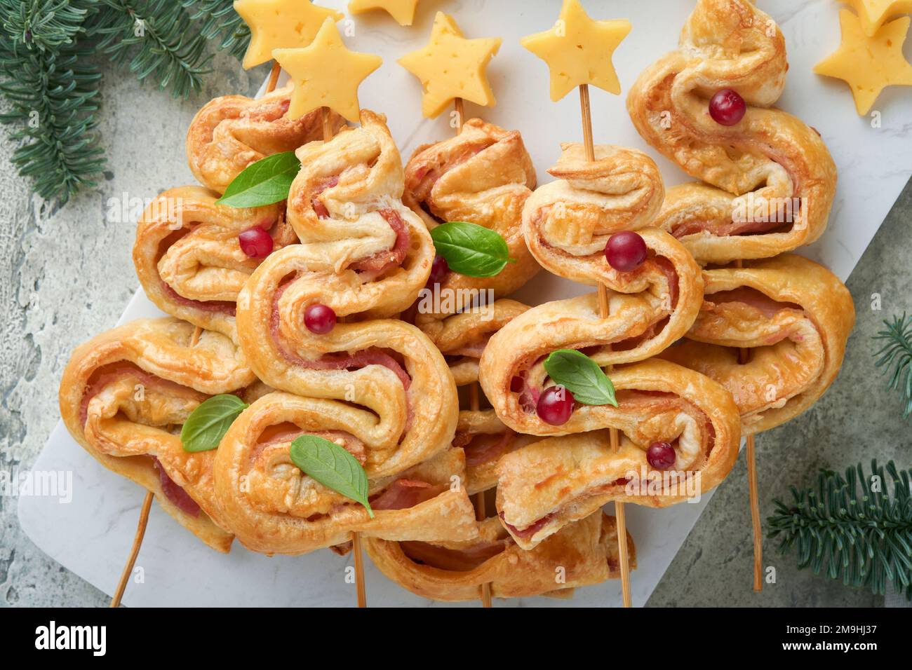 Christmas or New Year appetizer. Christmas tree shape puff pastry buns ...