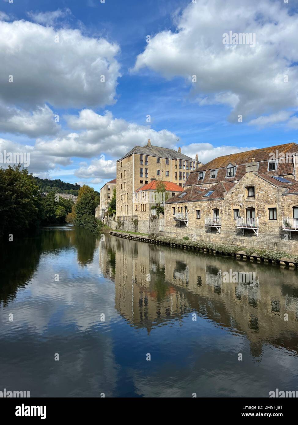 A scenic view of old residential buildings surrounded by a lake in a ...