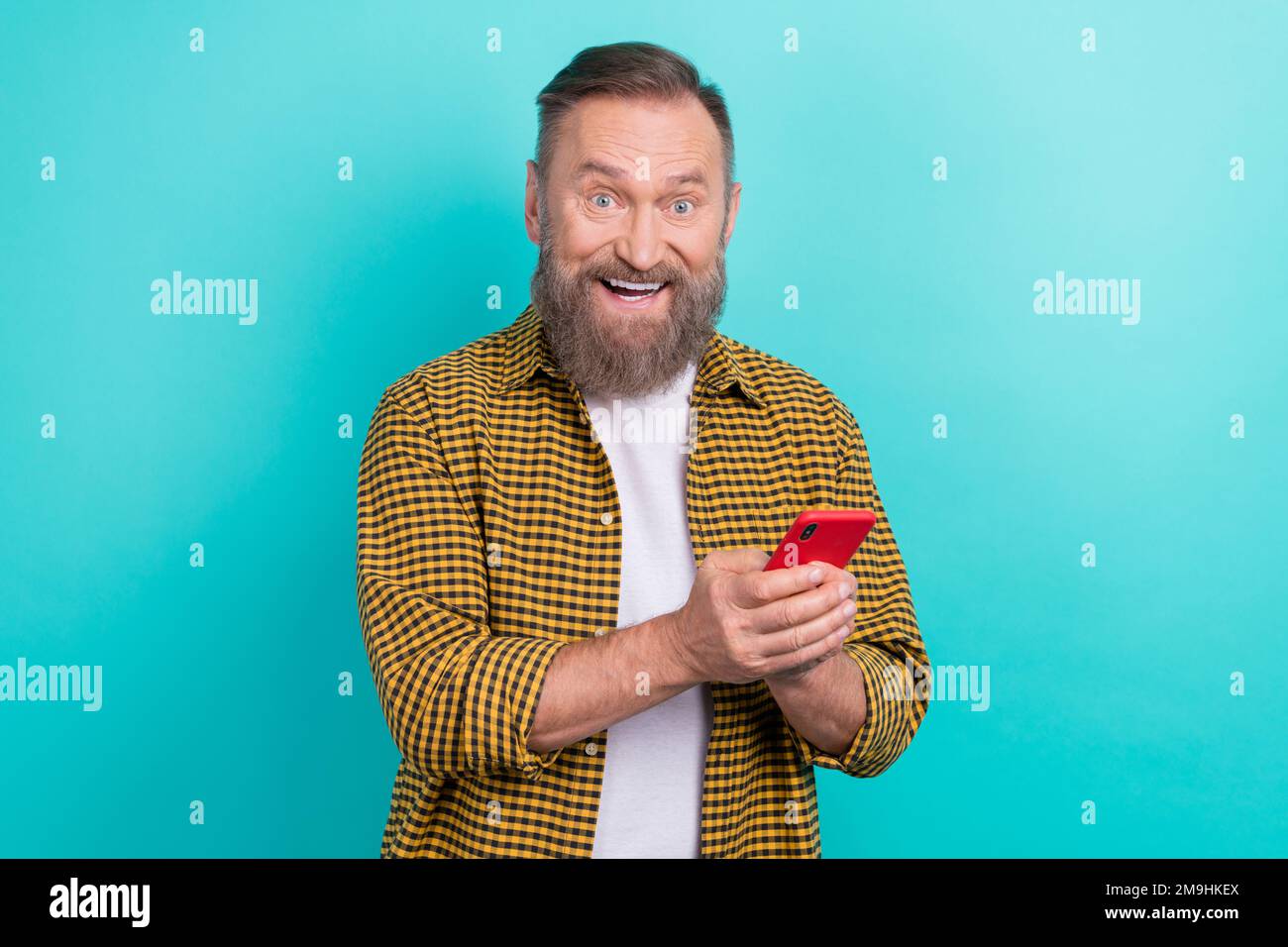 Photo of surprised funky man wear trendy yellow shirt hold his new ...