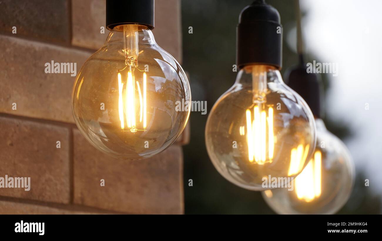 Old vintage light bulbs hanged outdoor Stock Photo - Alamy