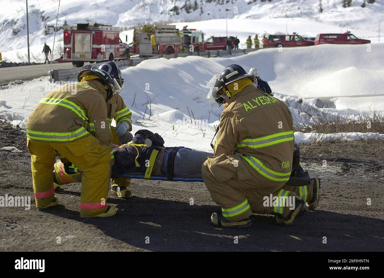 Members of the Alyeska fire brigade carry a victim to an ambulance ...