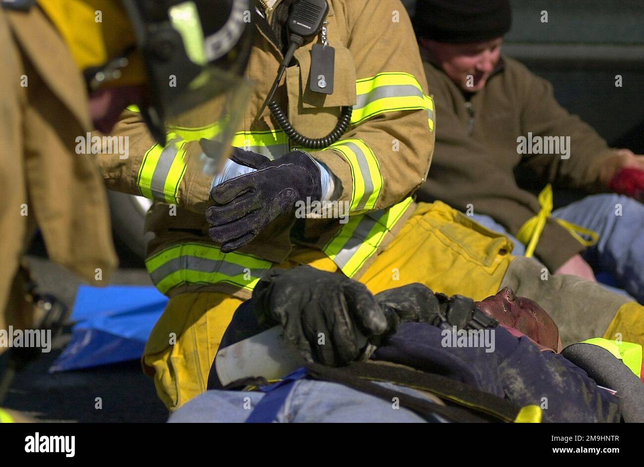 The Alyeska fire brigade, holds a victim down to prevent more injury ...