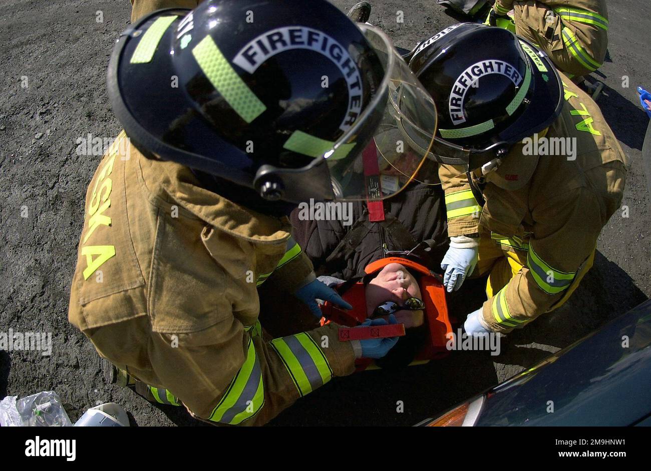 Members of the Alyeska fire brigade strap a victims head down to ...