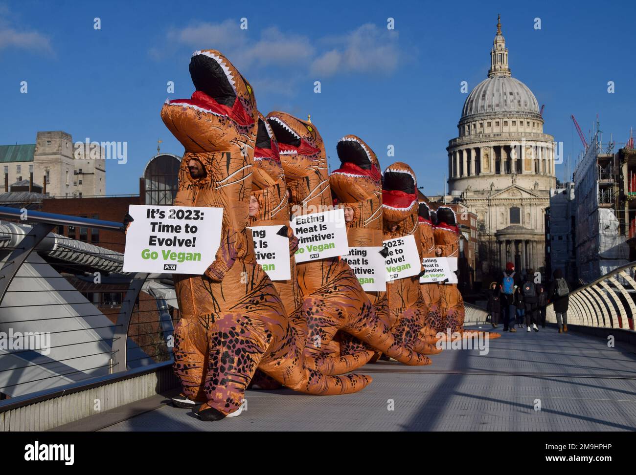 London, England, UK. 18th Jan, 2023. PETA activists wearing dinosaur costumes urge people to go ...