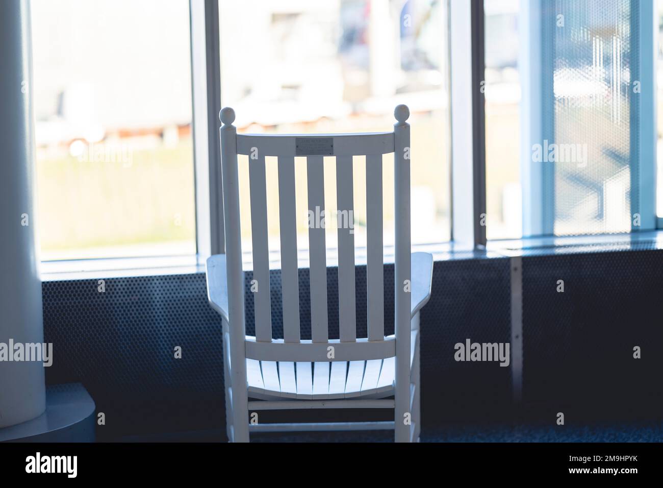 A back view of a white wooden rocking chair near a window Stock Photo ...