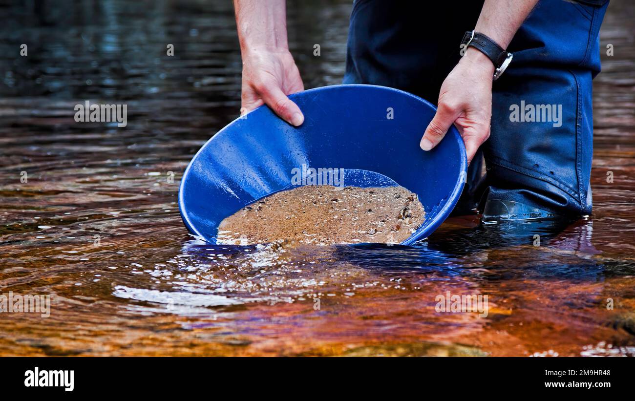 Man gold panning in the Kildonan Burn in Sutherland Stock Photo - Alamy