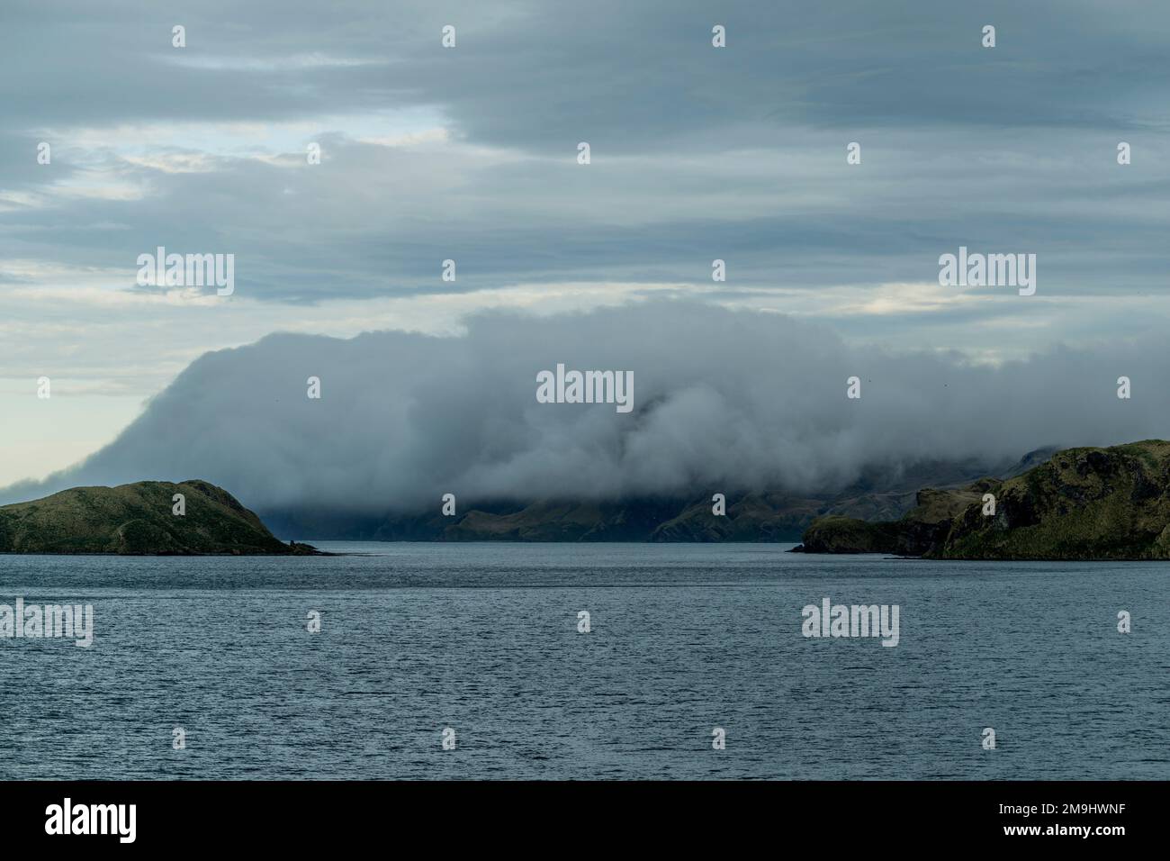 Clouds rolling in over the mountains into Stromness Bay on South ...