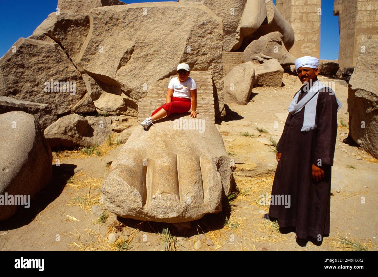 Luxor Egypt Ramesseum Child Sitting on Foot of Fallen Statue of Rameses ...