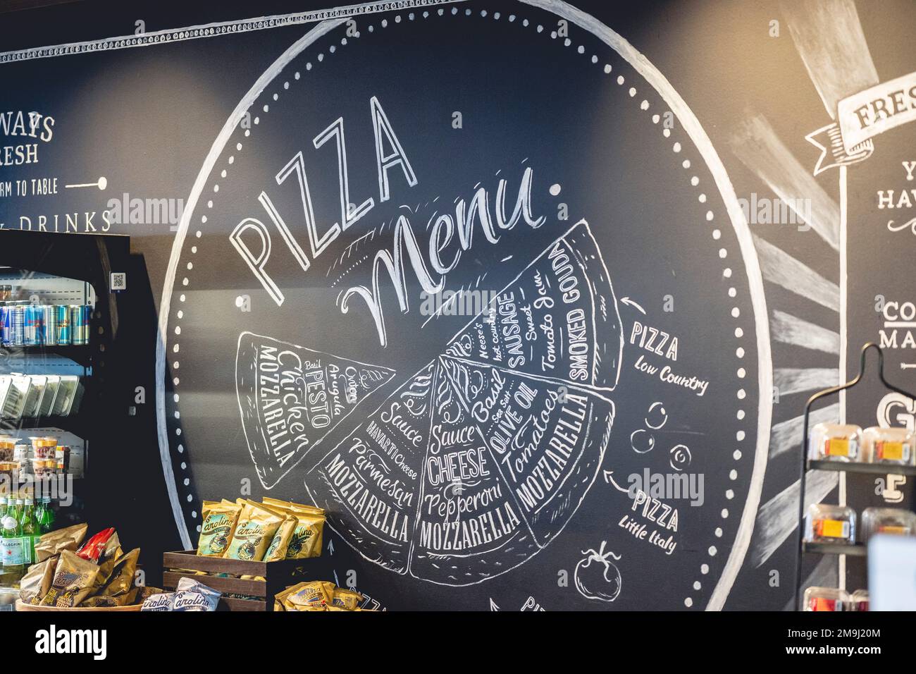 A large decorative wall design at a restaurant with the pizza menu ...