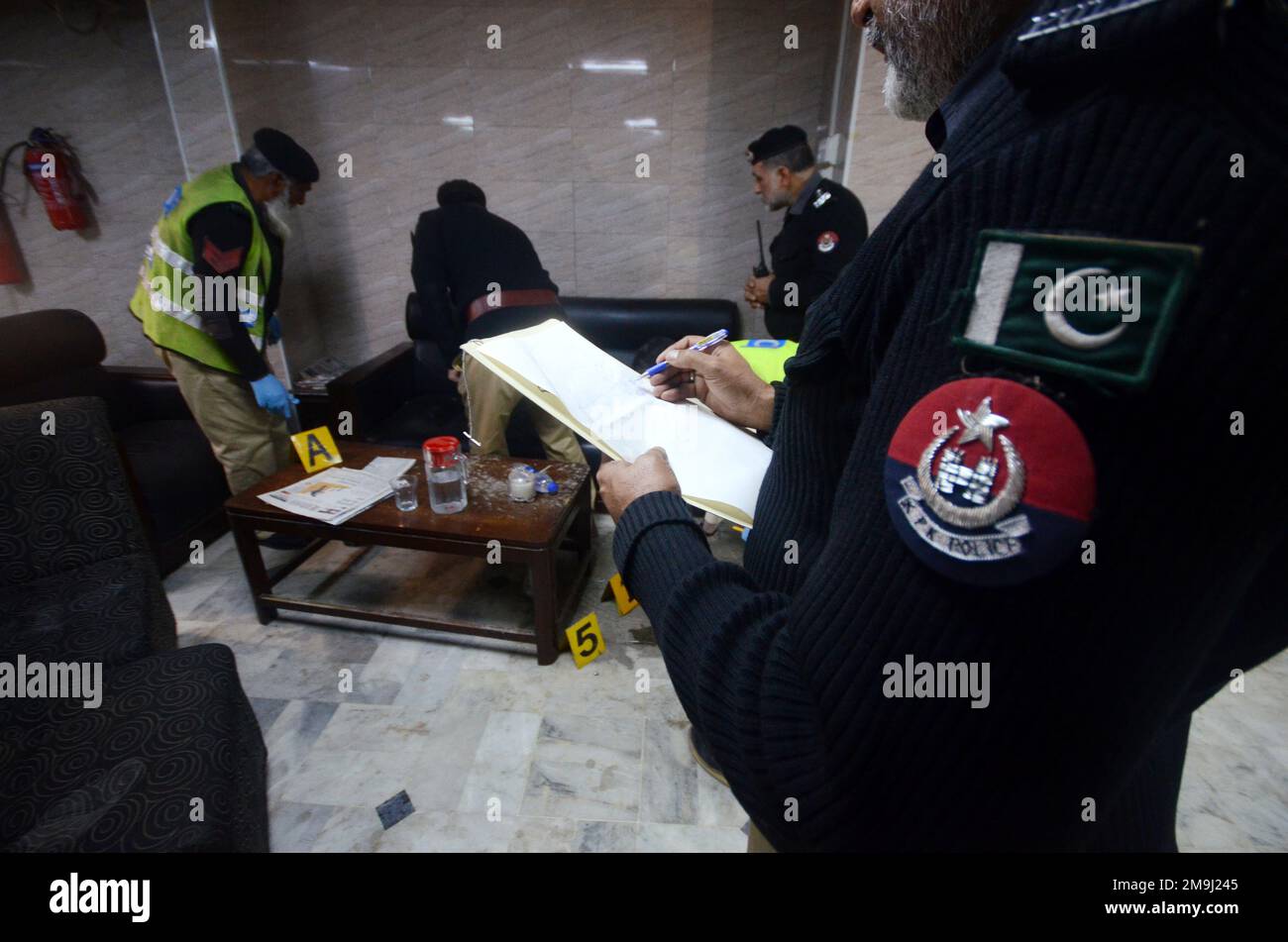 Pakistan. 16th Jan, 2023. Police officers examine the crime scene ...