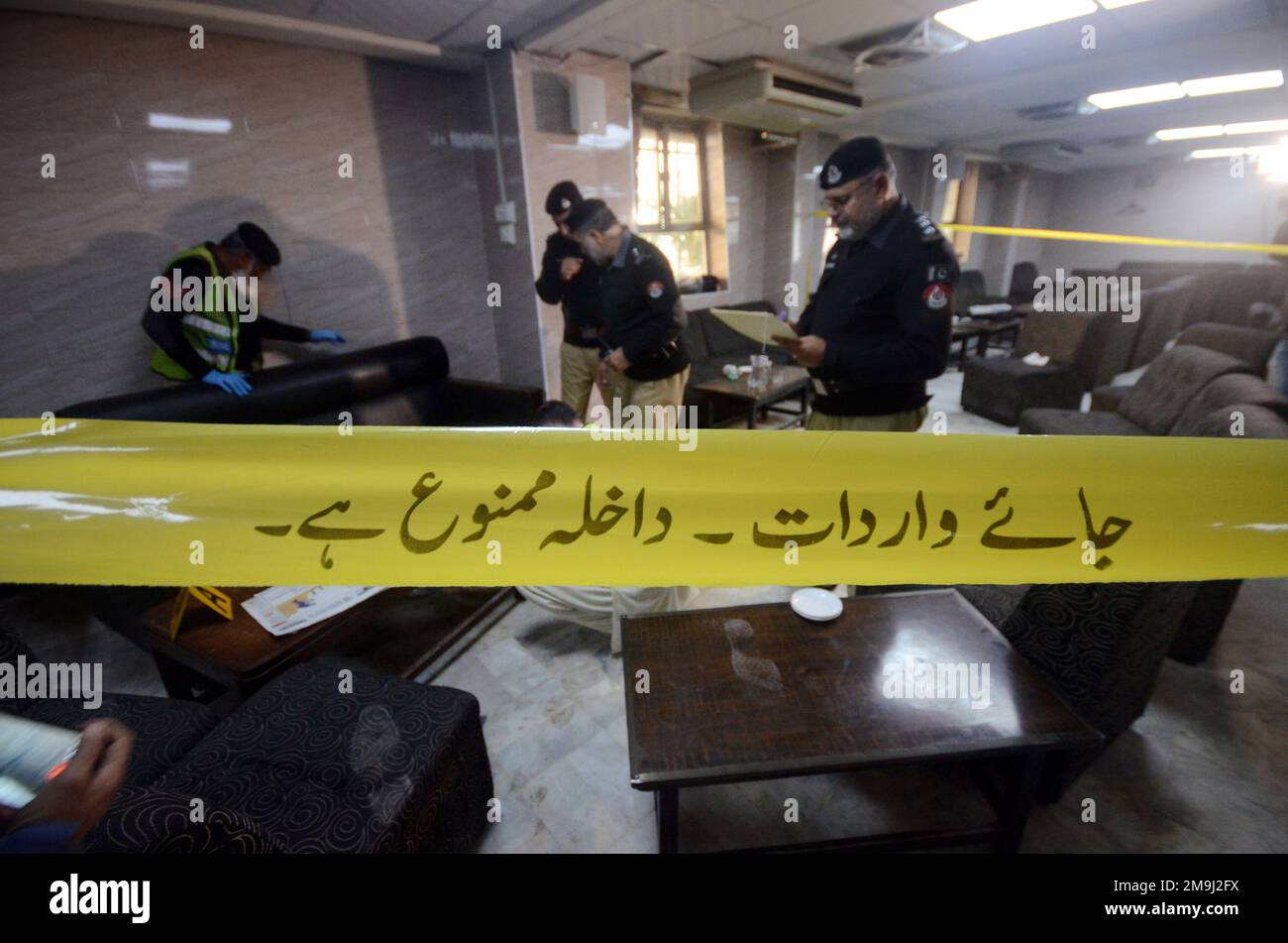 Pakistan. 16th Jan, 2023. Police officers examine the crime scene ...