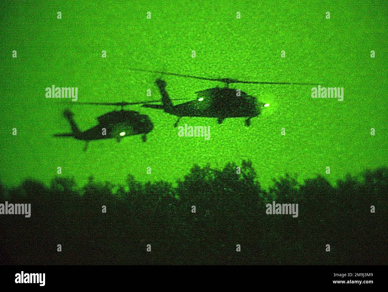 Light enhanced photography showing two US Army (USA) UH-60A Black Hawk ...