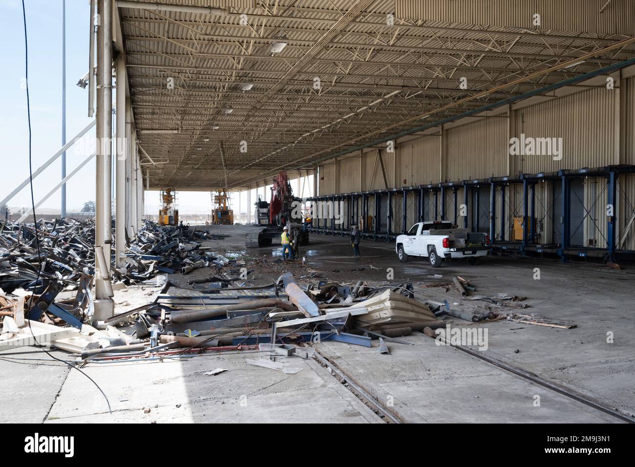 Construction crew members demolish the Mechanized Material Handling ...