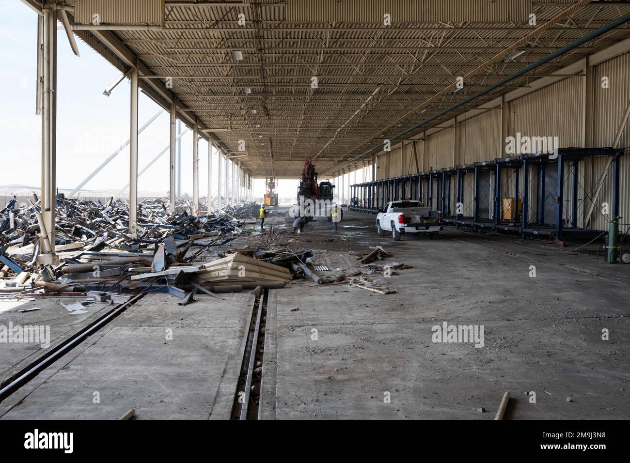 Construction crew members demolish the Mechanized Material Handling ...