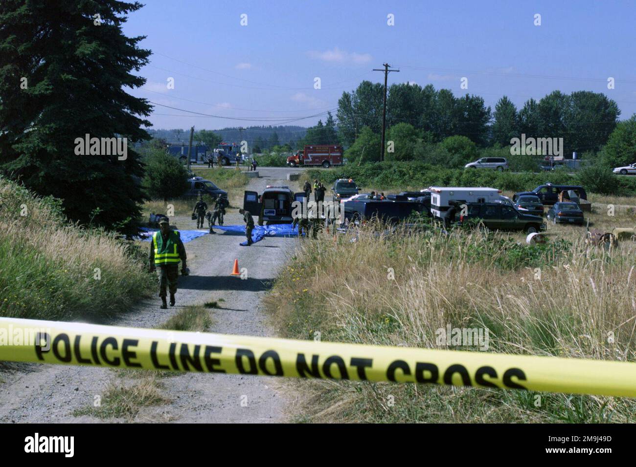 020715-F-5735S-012. [Complete] Scene Caption: Military and Civilian ...