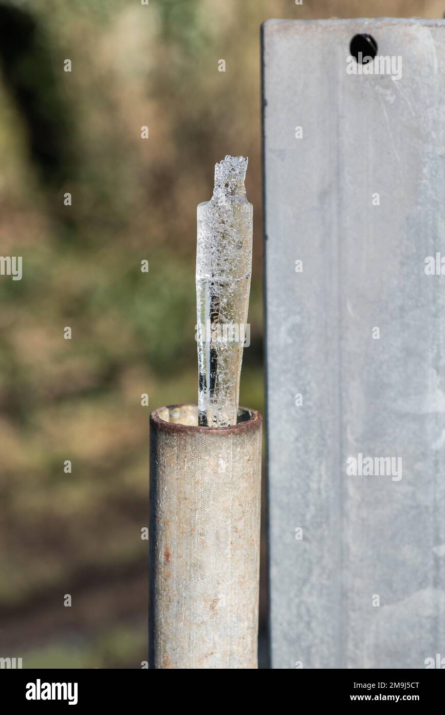 Water collects inside a vertical metal pipe hi-res stock photography ...