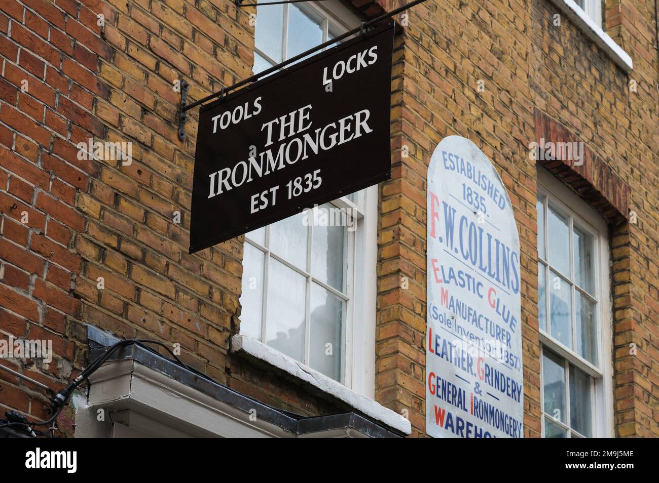 The Ironmonger, signs on wall above shops in Monmouth Street, Seven ...