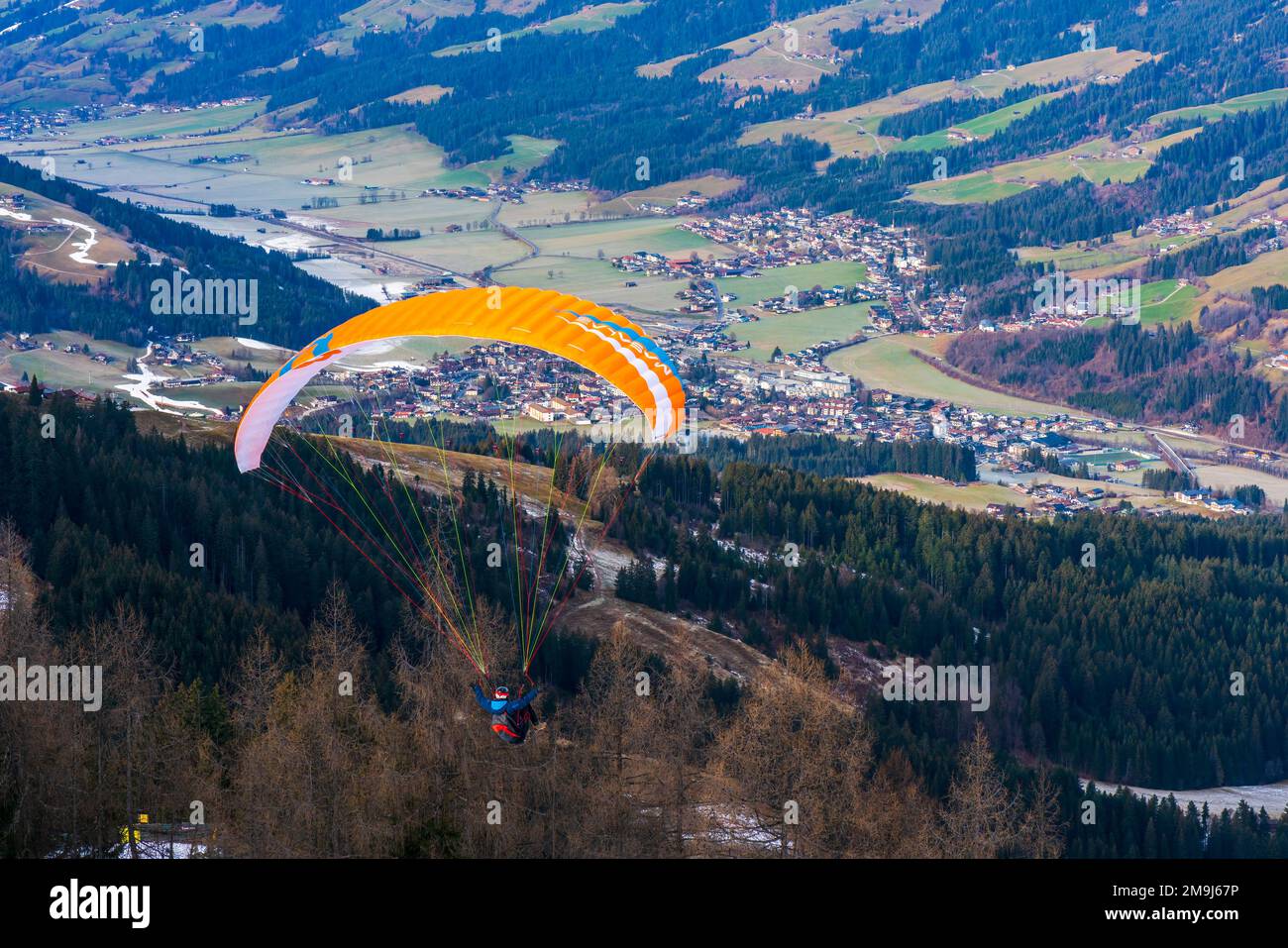 Paraglider flies over mountains ski hi-res stock photography and images ...