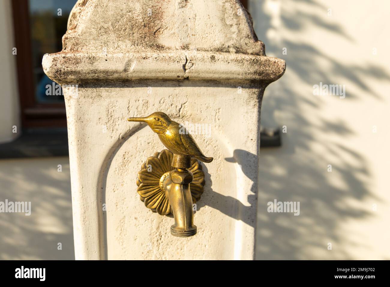 Artistic tap with water, tap in the shape of a golden bird Stock Photo ...