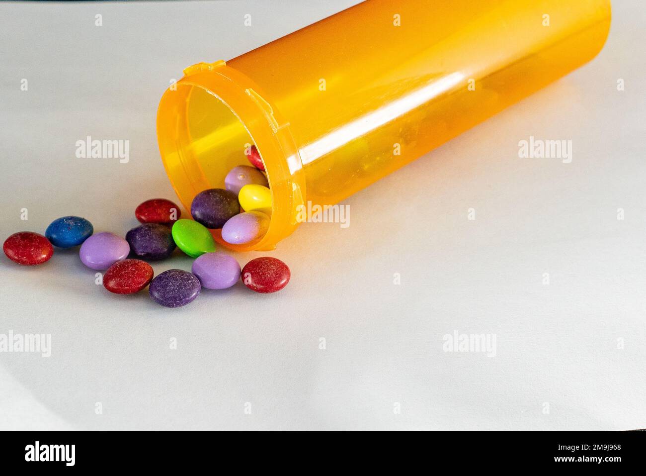 Colored pills on white background Stock Photo - Alamy
