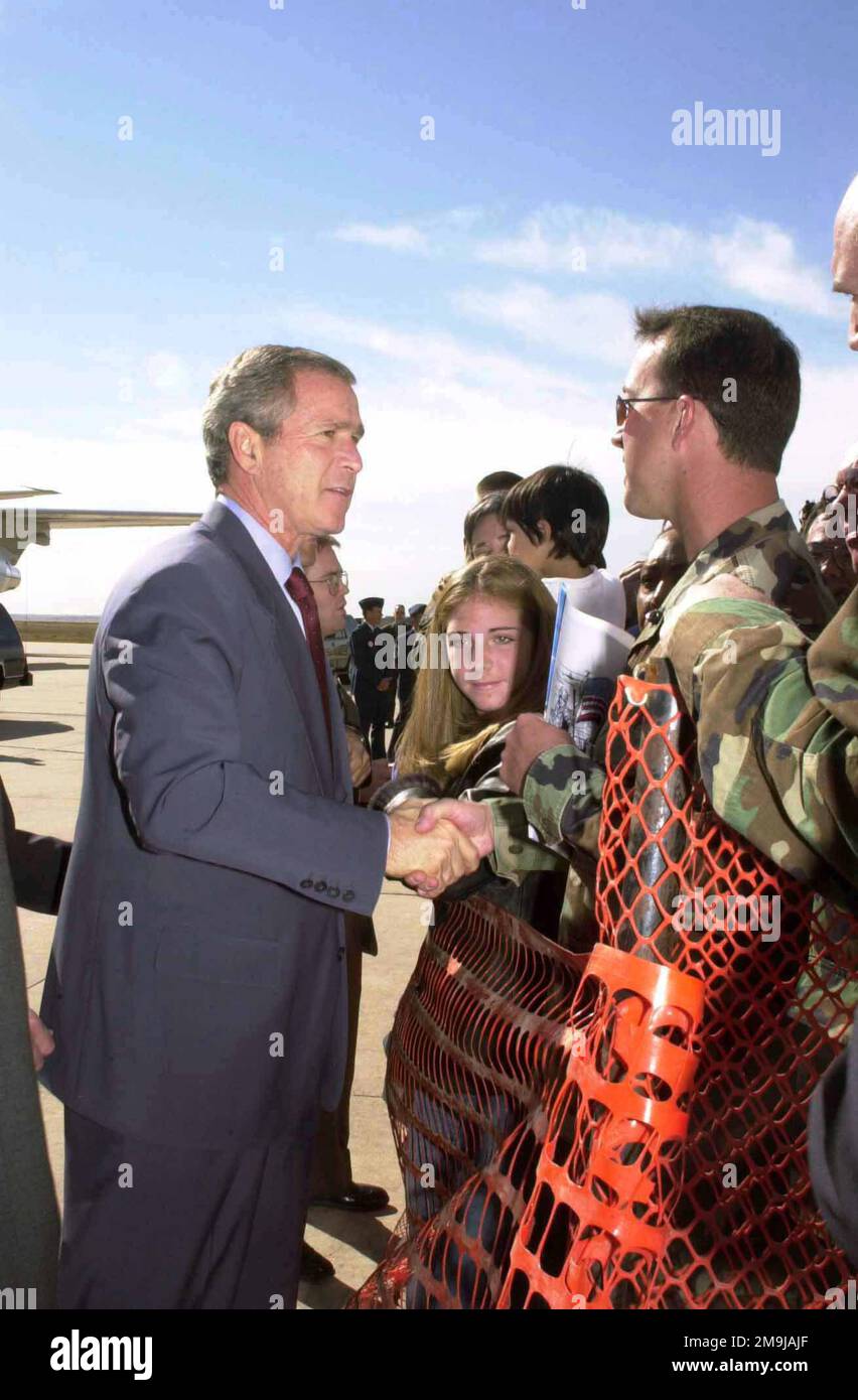 US President George W. Bush (left) greets personnel at Buckley Air ...