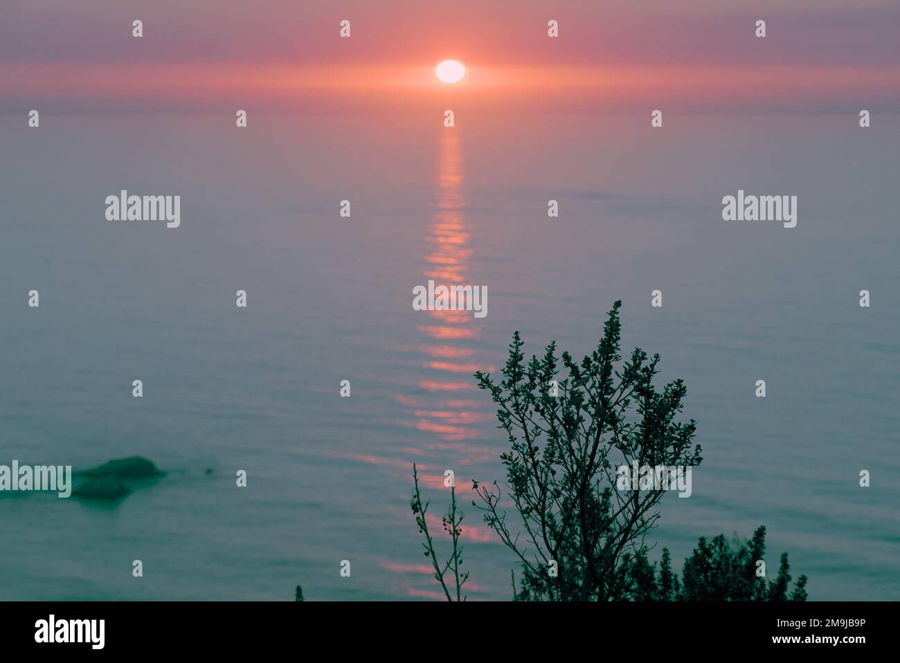 Sunset and the reflection of the red sun light in the the middle of the ...