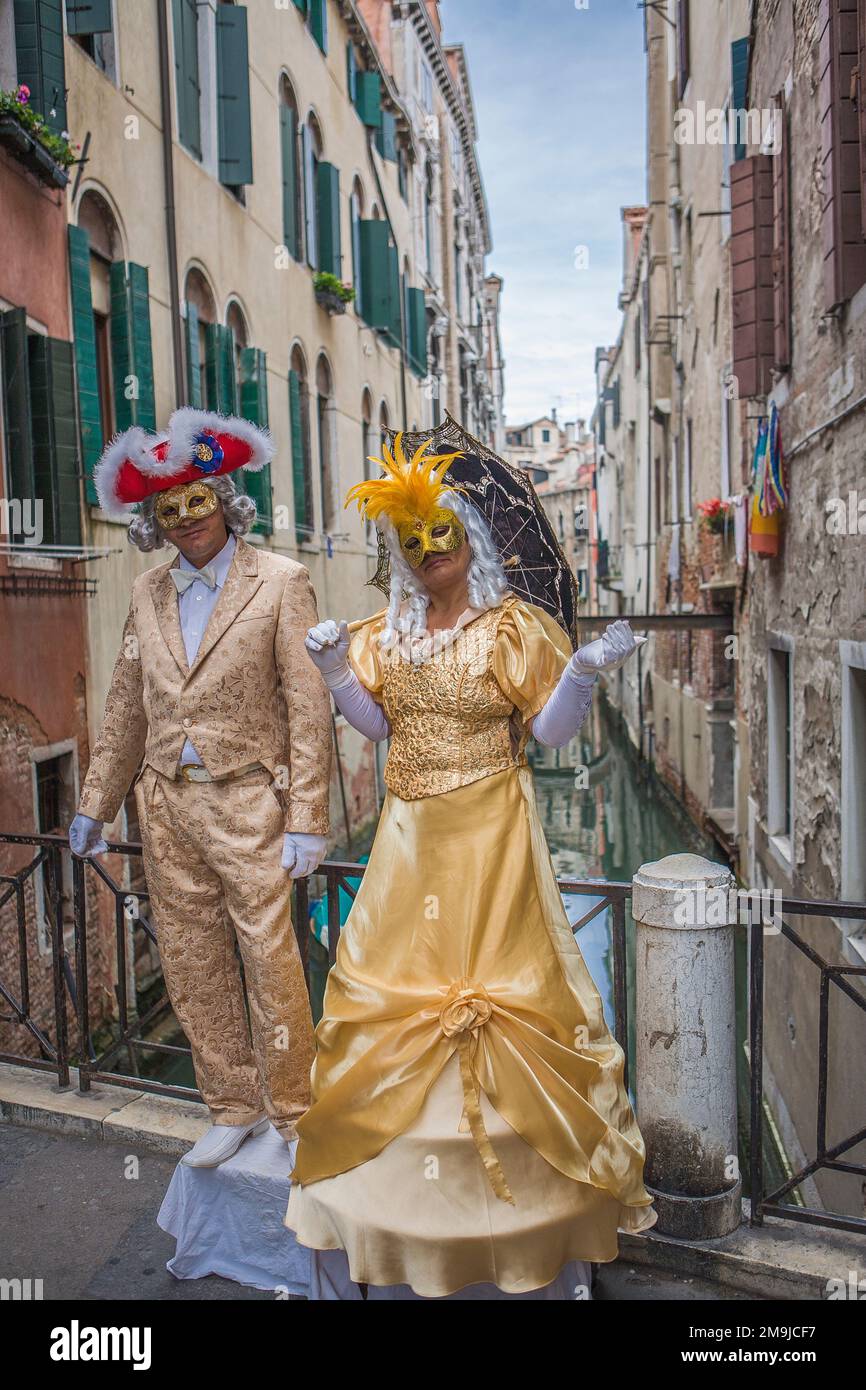 Venetian masked street performers dressed in carnival costumes ...
