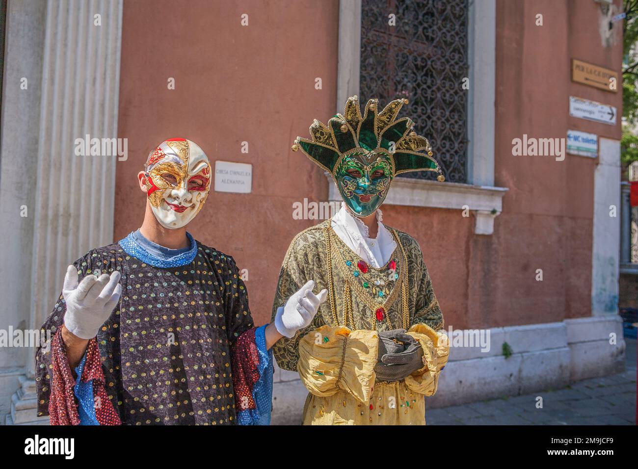 Venetian masked street performers dressed in carnival costumes ...