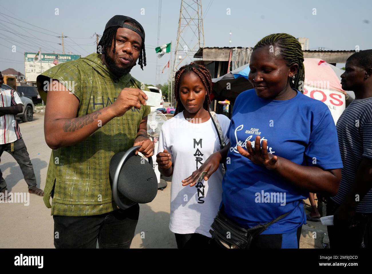 Nigeria's Rapper Dandizzy, left, freestyles a song on the Street urging ...