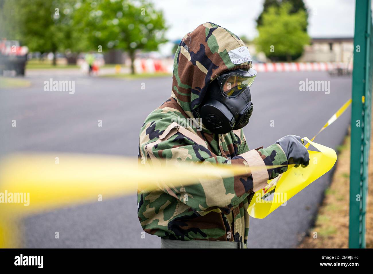 An Airman from the 423d Civil Engineer Squadron, places a marking sign ...