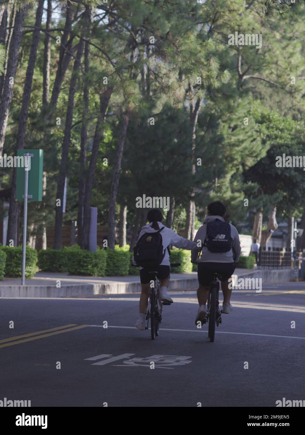 Two young students riding hi-res stock photography and images - Alamy