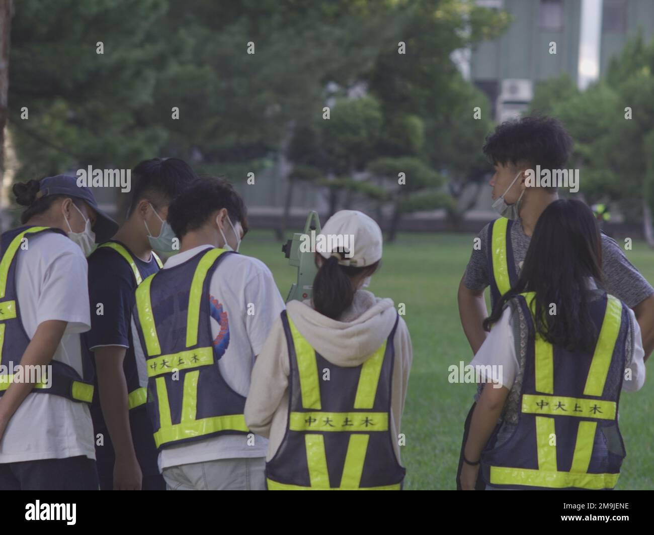 The students wearing reflective vests in a university campus Stock ...