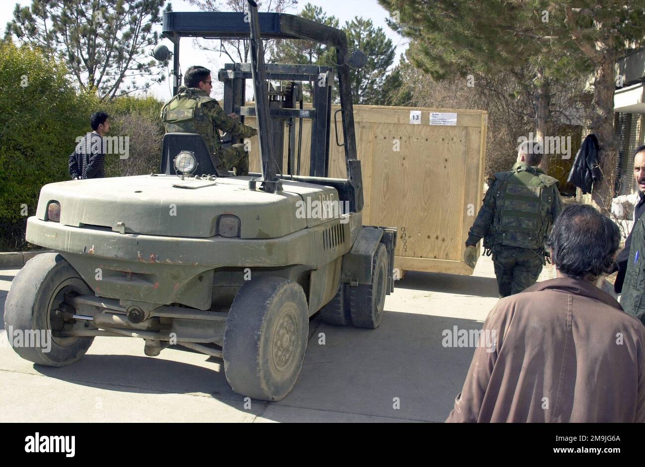 Two soldiers of the Spanish Army use a forklift to move heavy equipment ...