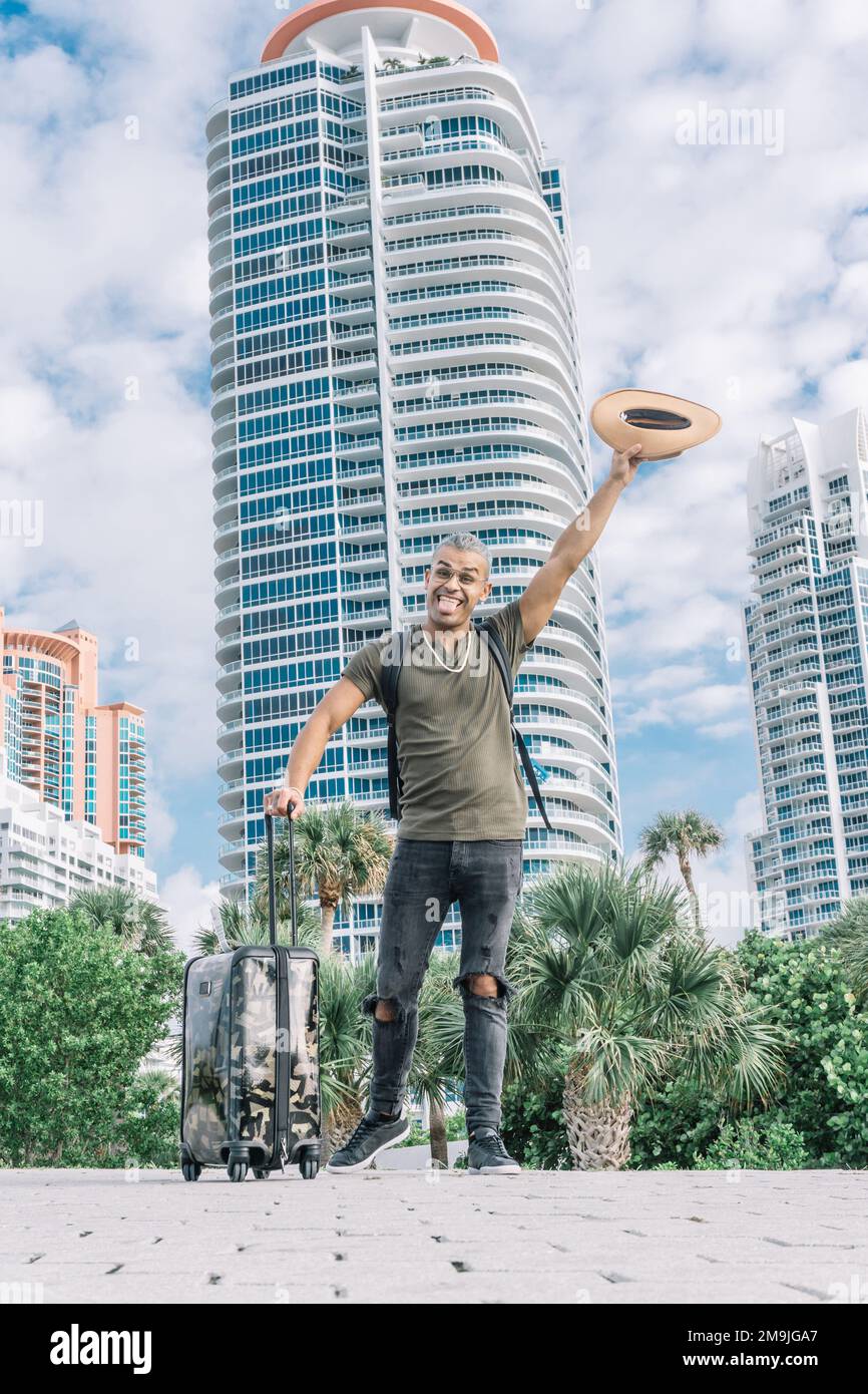 man waving with his hat to say goodbye happy and making a face. A fancy ...