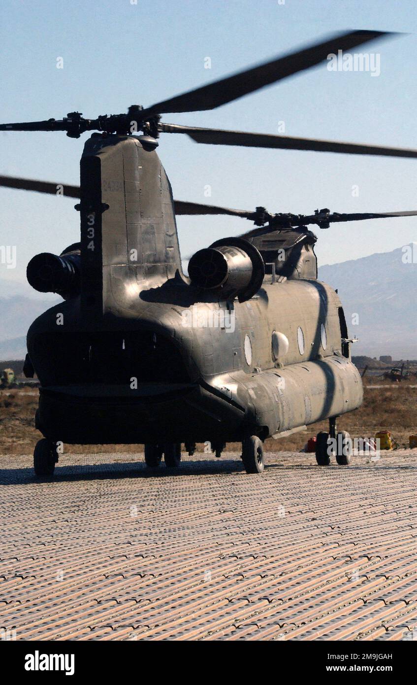 A CH-47 Chinook helicopter sits on the runway at Bagram Airfield, in ...