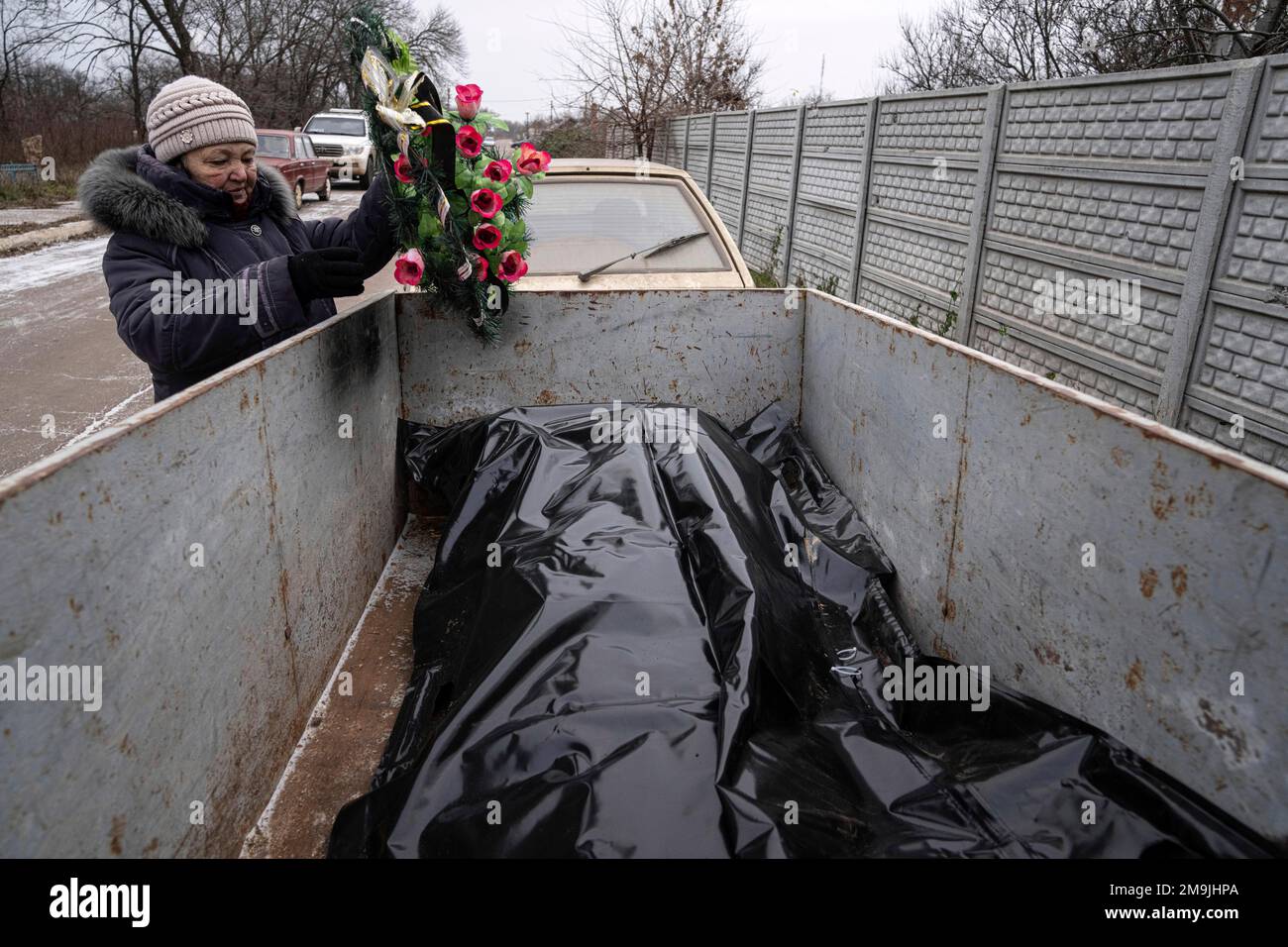 Tamila Pyhyda place flowers with the body of her husband Serhii who was ...
