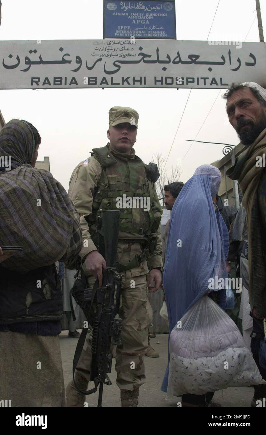 A US Army (USA) soldier armed with a Colt 5.56mm M16A2 rifle, guards ...