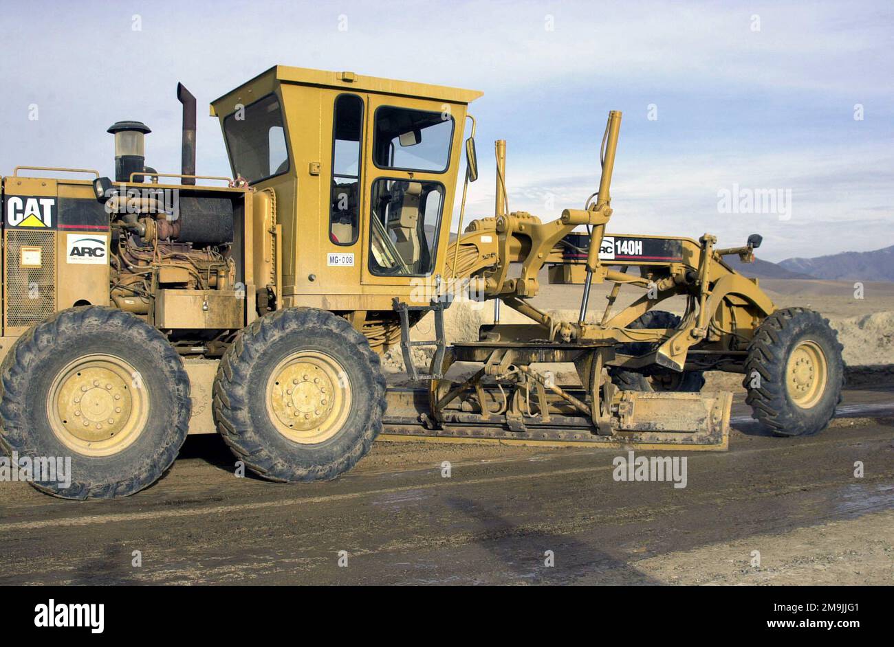 A construction worker uses a grader to revitalize a road at the Mine ...