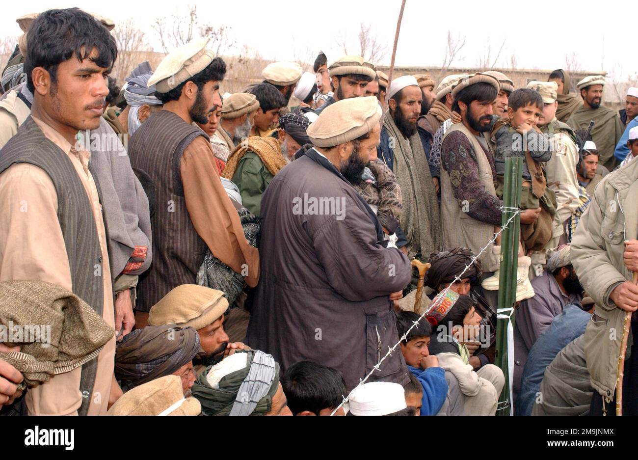 A group of local Afghans gather in the small village of Aroki for a ...