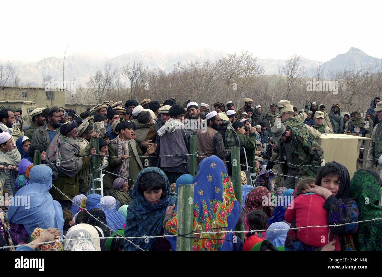 Afghan locals wait in line for medical treatment during a Medical Civil ...
