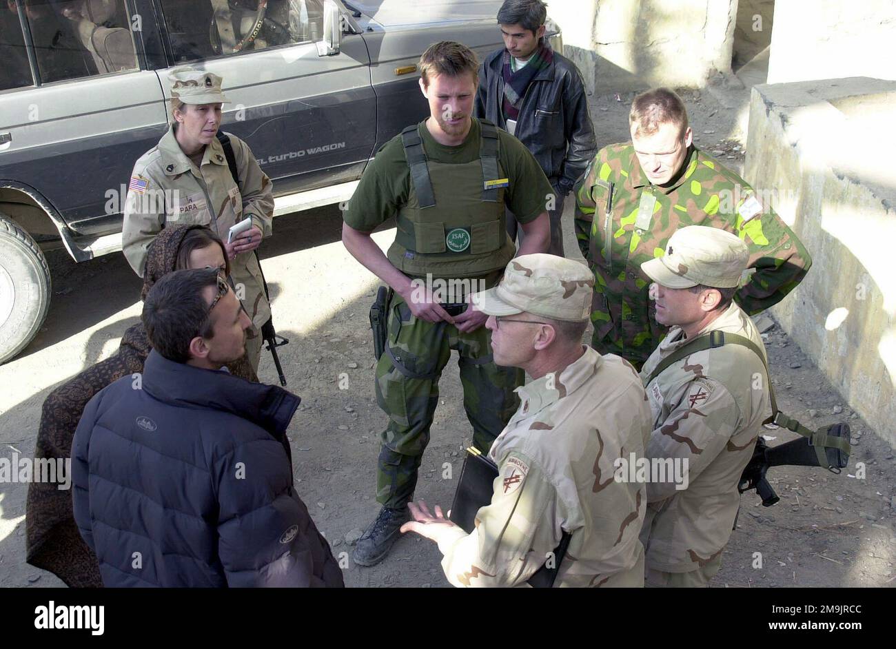 US Army (USA) Major (MAJ) Timothy Downs, center, with the Coalition ...