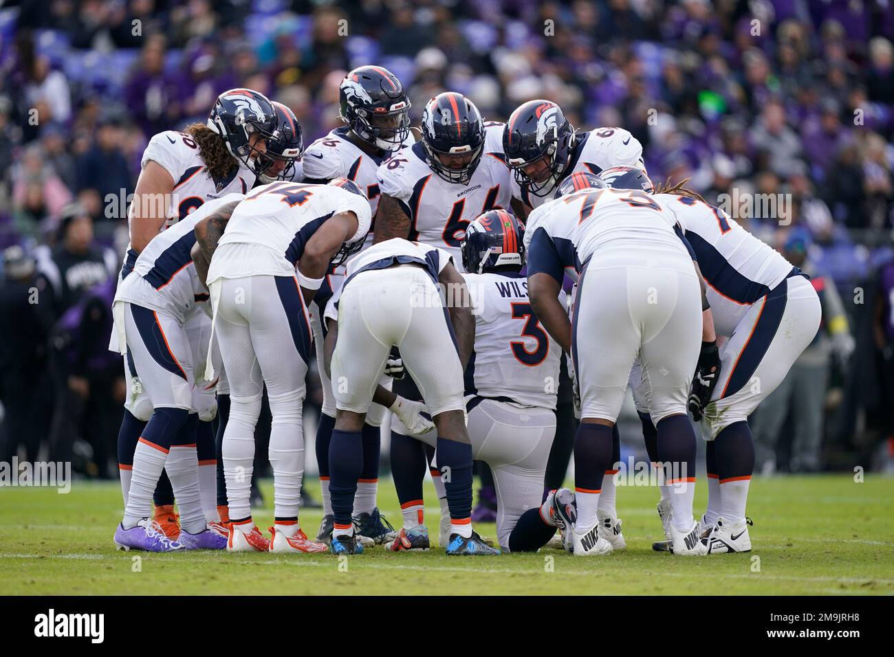 Denver Broncos quarterback Russell Wilson (3) huddles with teammates ...