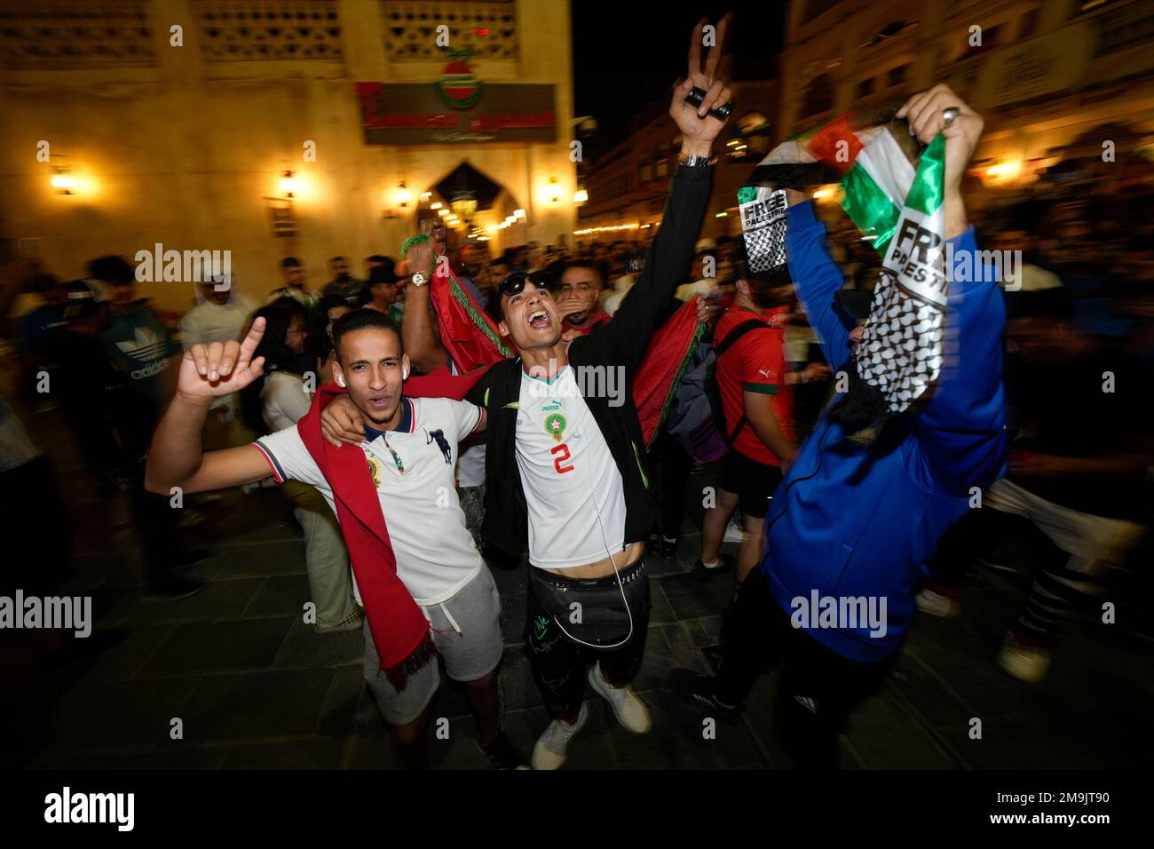 Moroccan and Palestinian soccer fans dance at the Souq Waqif during the ...