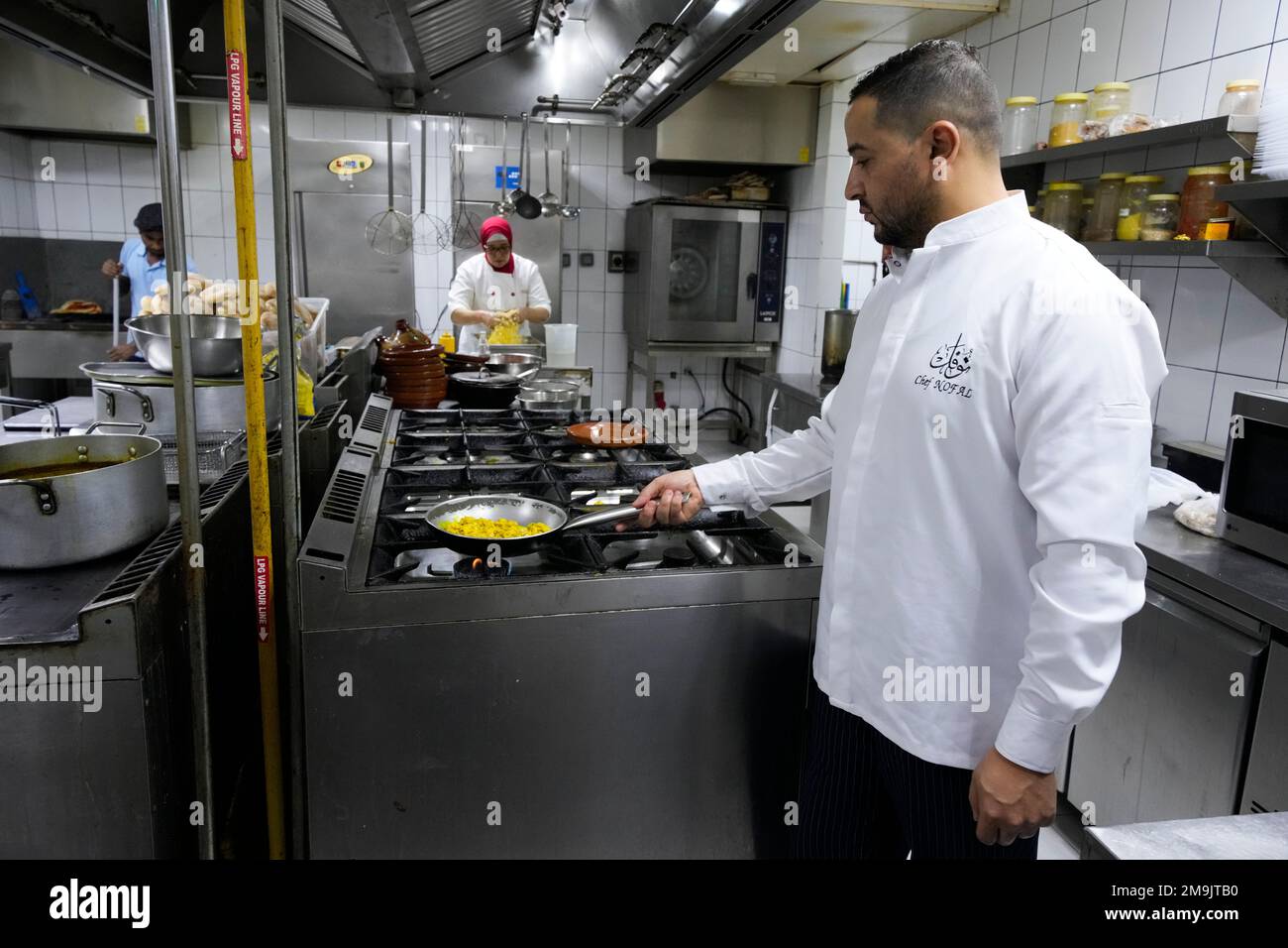 Moroccan chefs Naoufel Farih, right, and Fatma Taouzani, center ...
