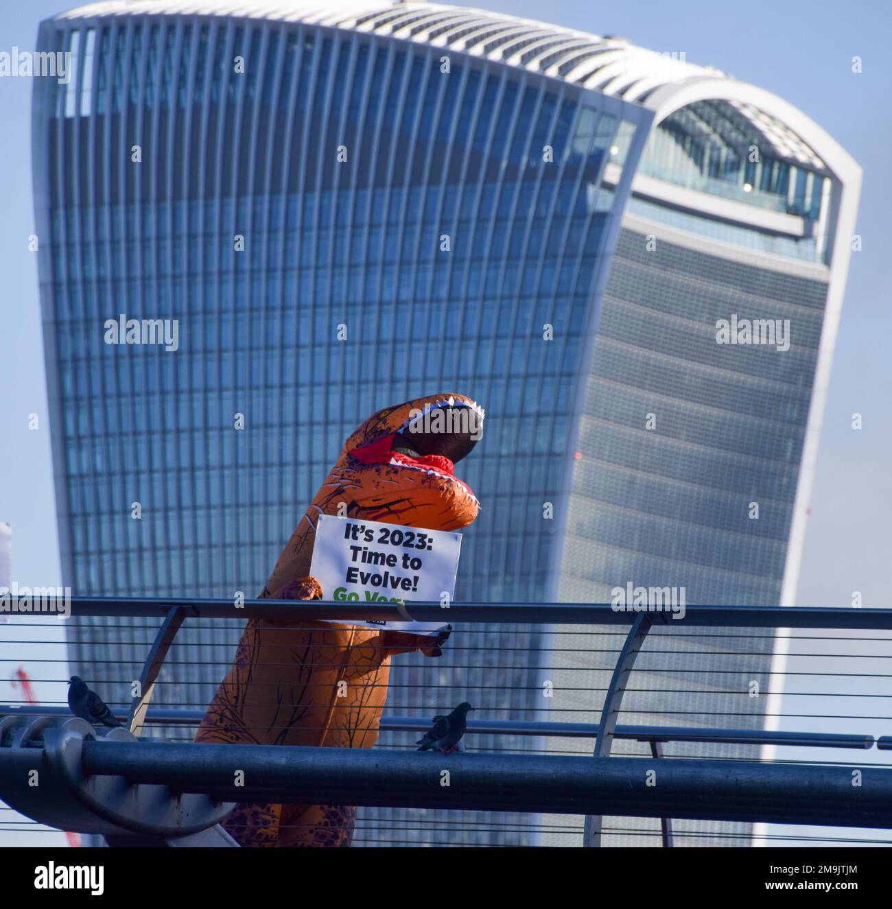 London, UK. 18th January 2023. PETA activists wearing dinosaur costumes urge people to go vegan ...